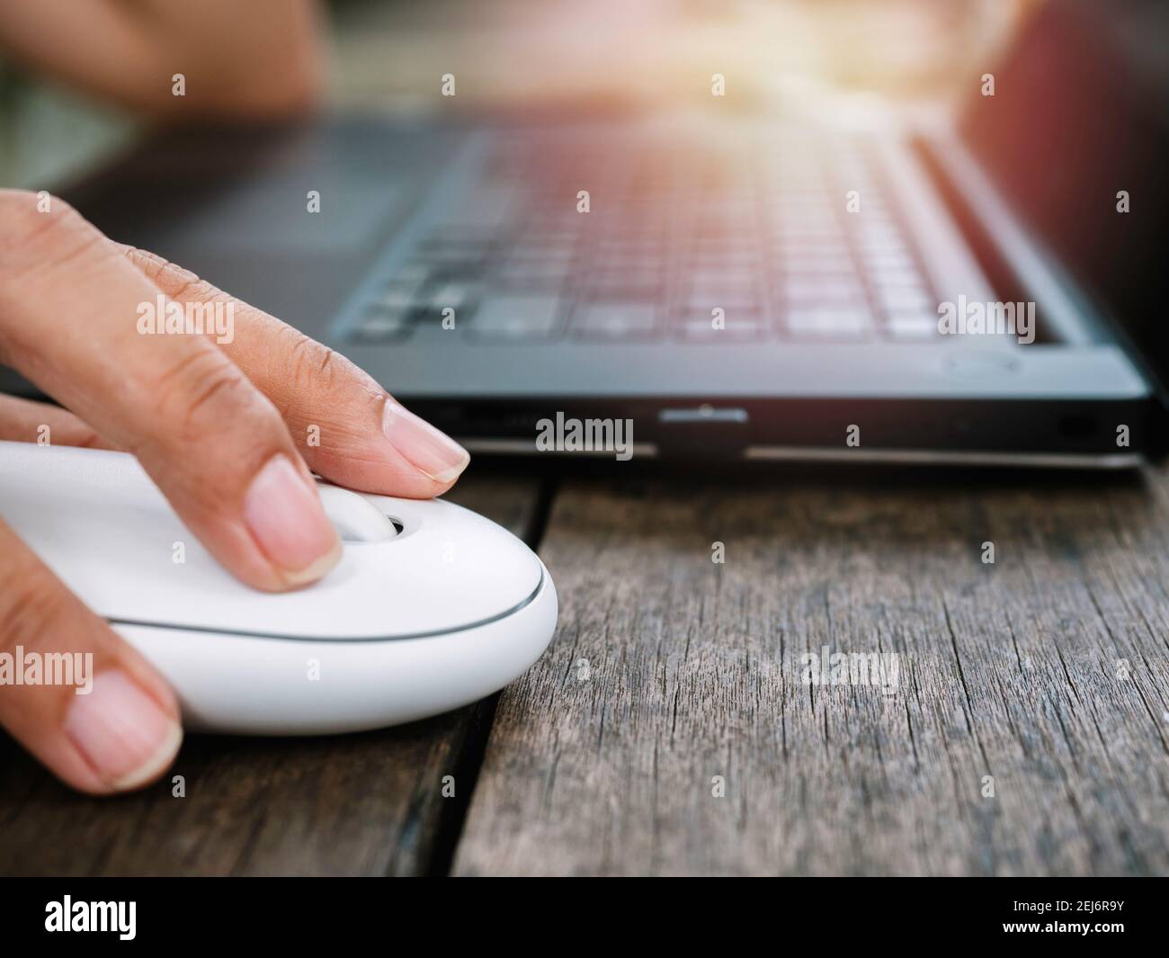 Close up finger using modern white wireless mouse while working on ...