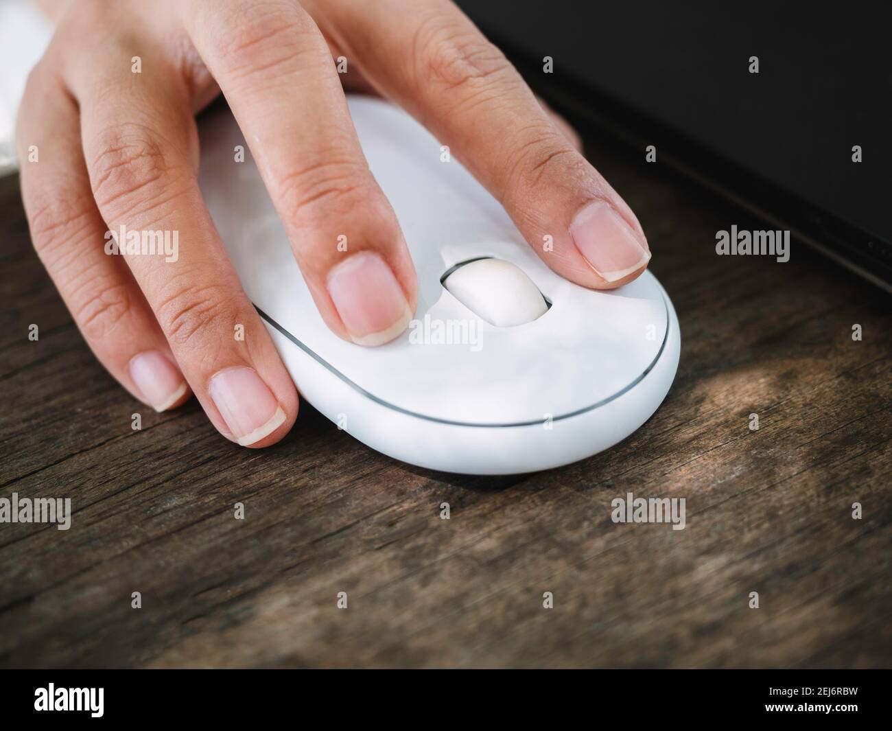 Close up finger using modern white wireless mouse while working on ...