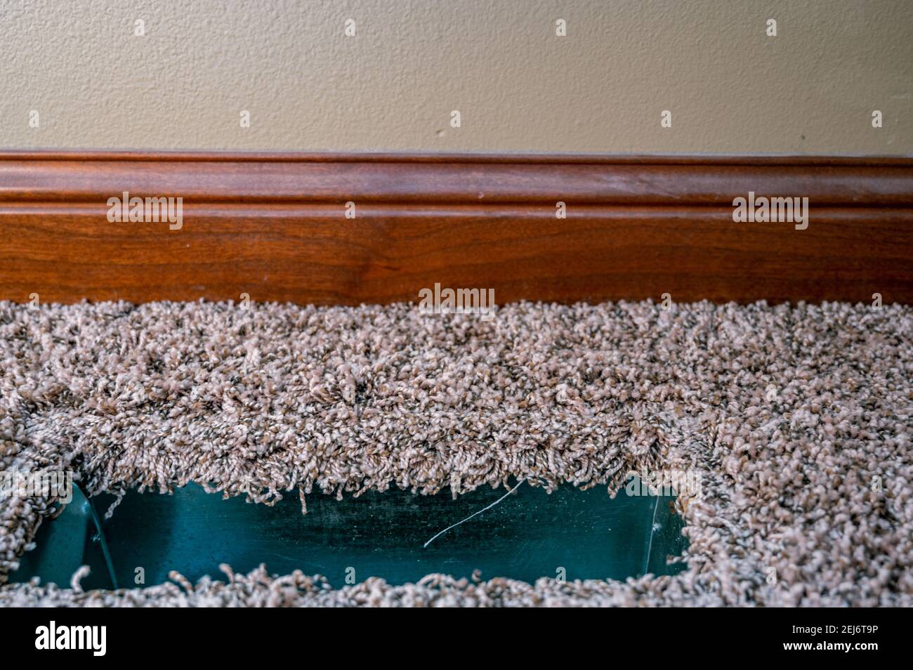 HVAC floor vent opened with carpet and piping visible Stock Photo - Alamy
