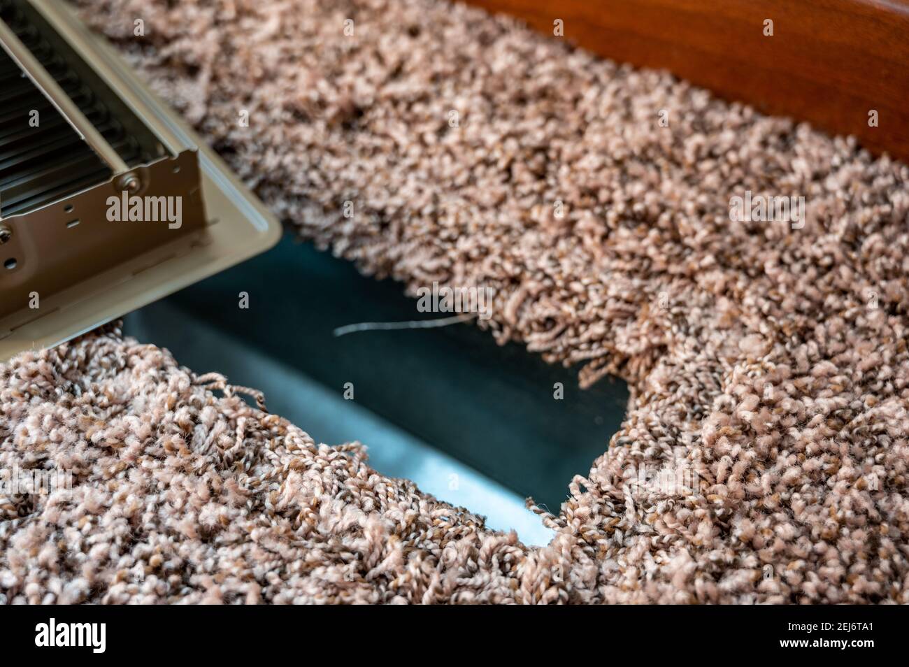 HVAC floor vent opened with carpet and piping visible Stock Photo - Alamy