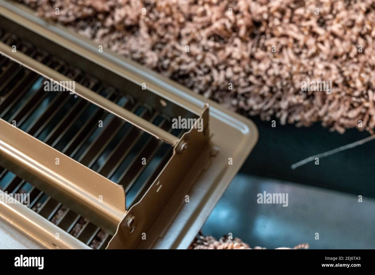 HVAC floor vent opened with carpet and piping visible Stock Photo - Alamy
