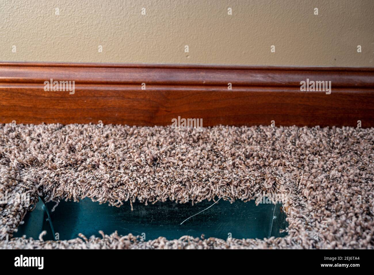 HVAC floor vent opened with carpet and piping visible Stock Photo - Alamy