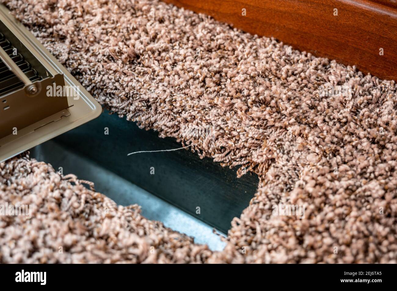 HVAC floor vent opened with carpet and piping visible Stock Photo - Alamy
