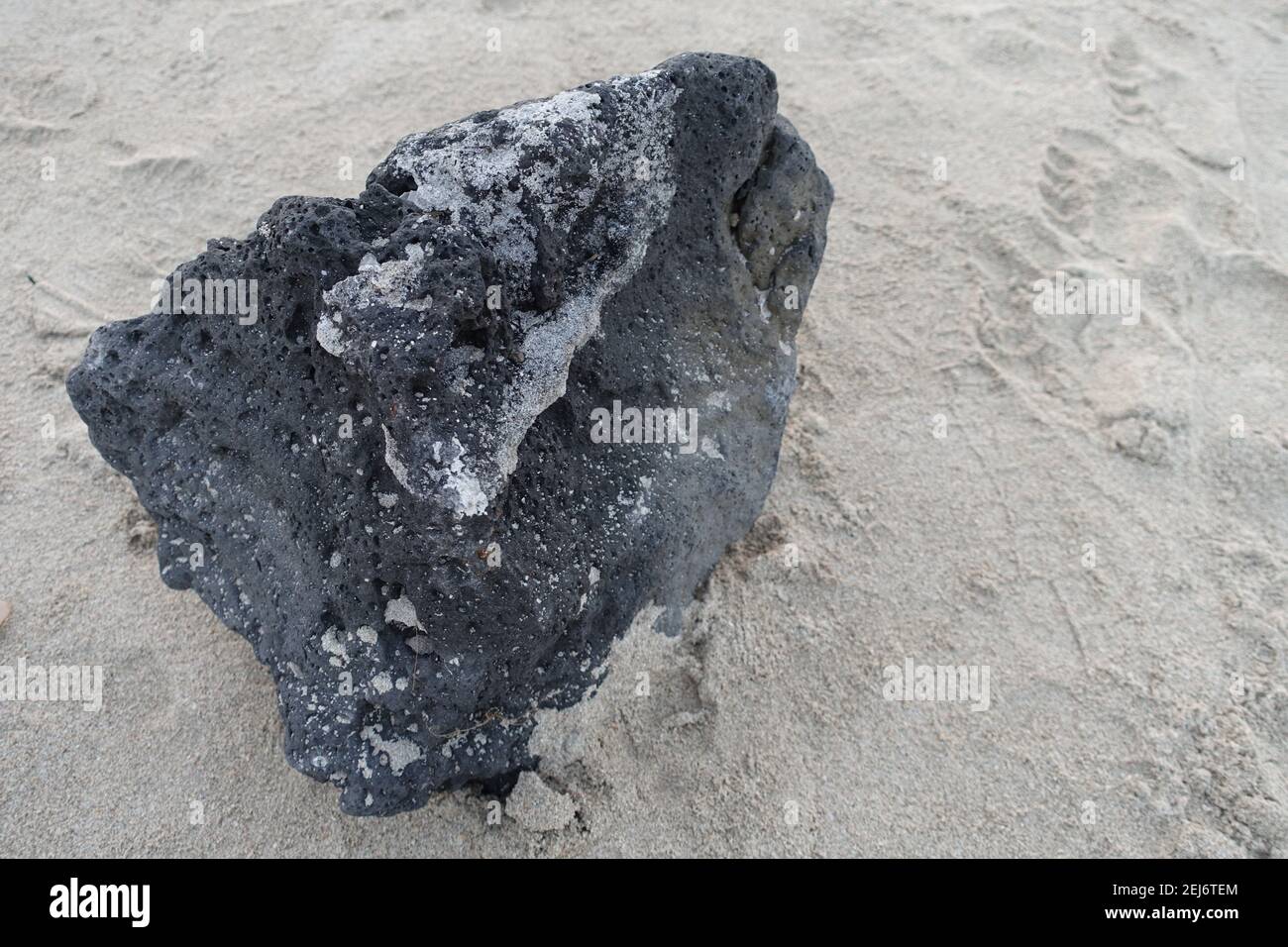 A picture of basalt on the sandy beach Stock Photo - Alamy