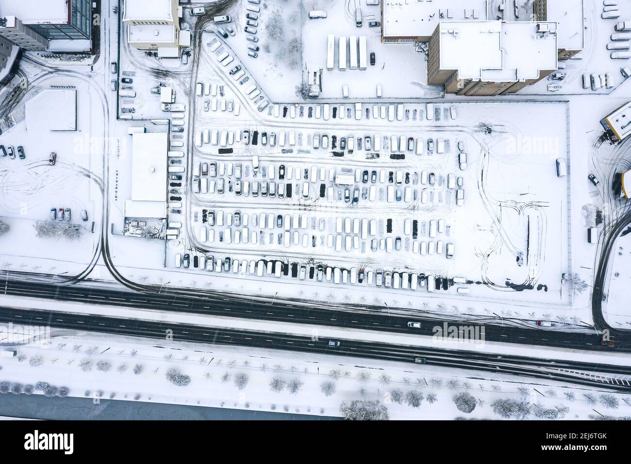 outdoor parking lot in suburb district with parked cars at winter time ...