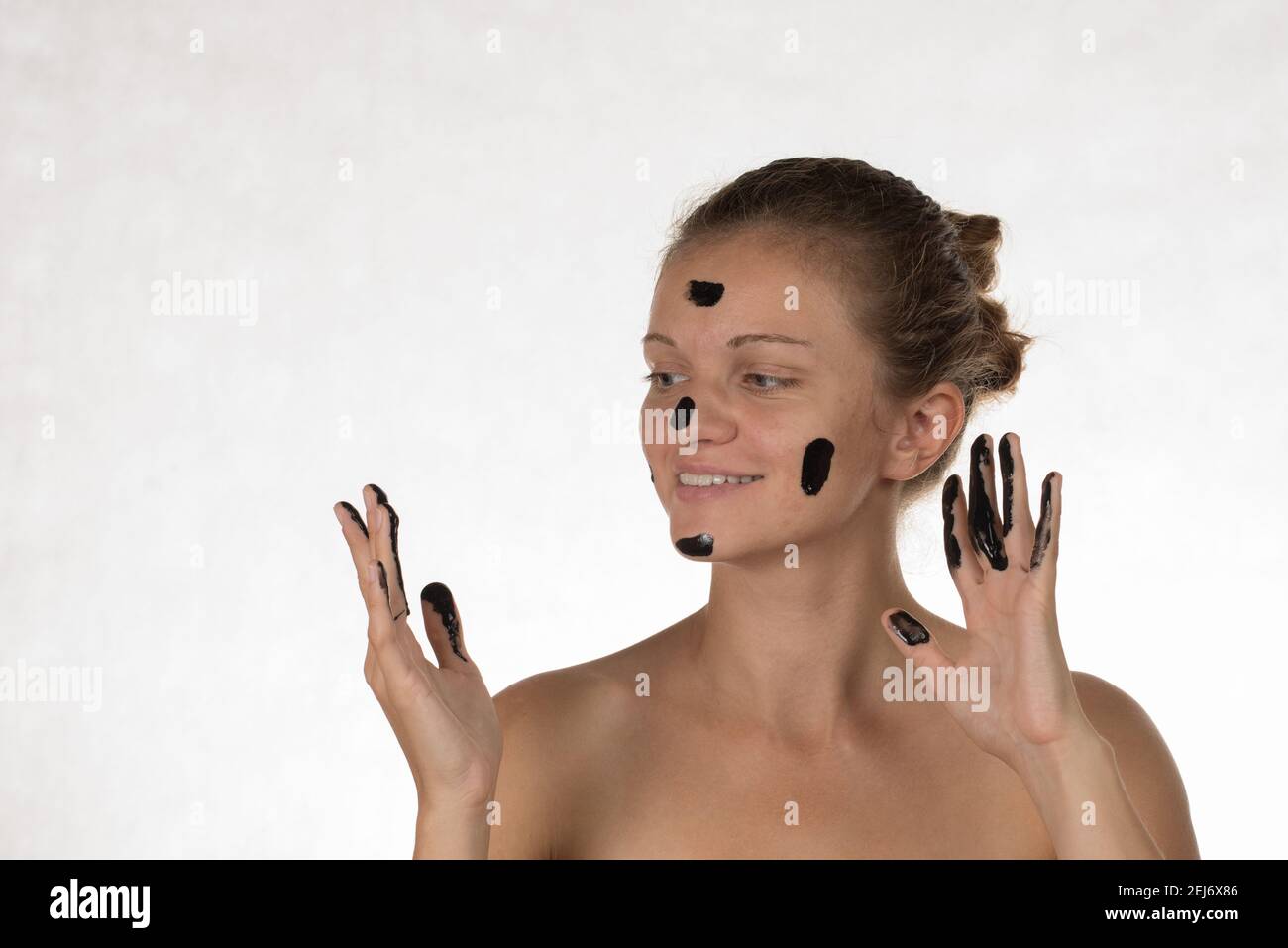 Happy beautiful girl with acne smiling on a white background in a ...