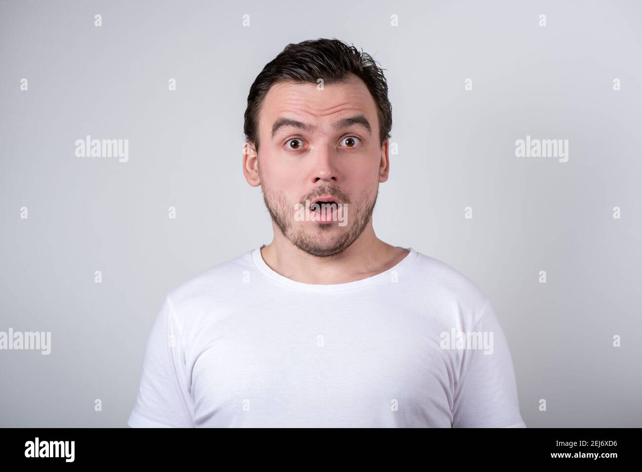 Handsome Brunette Guy With Bristles In A White T Shirt Makes Funny