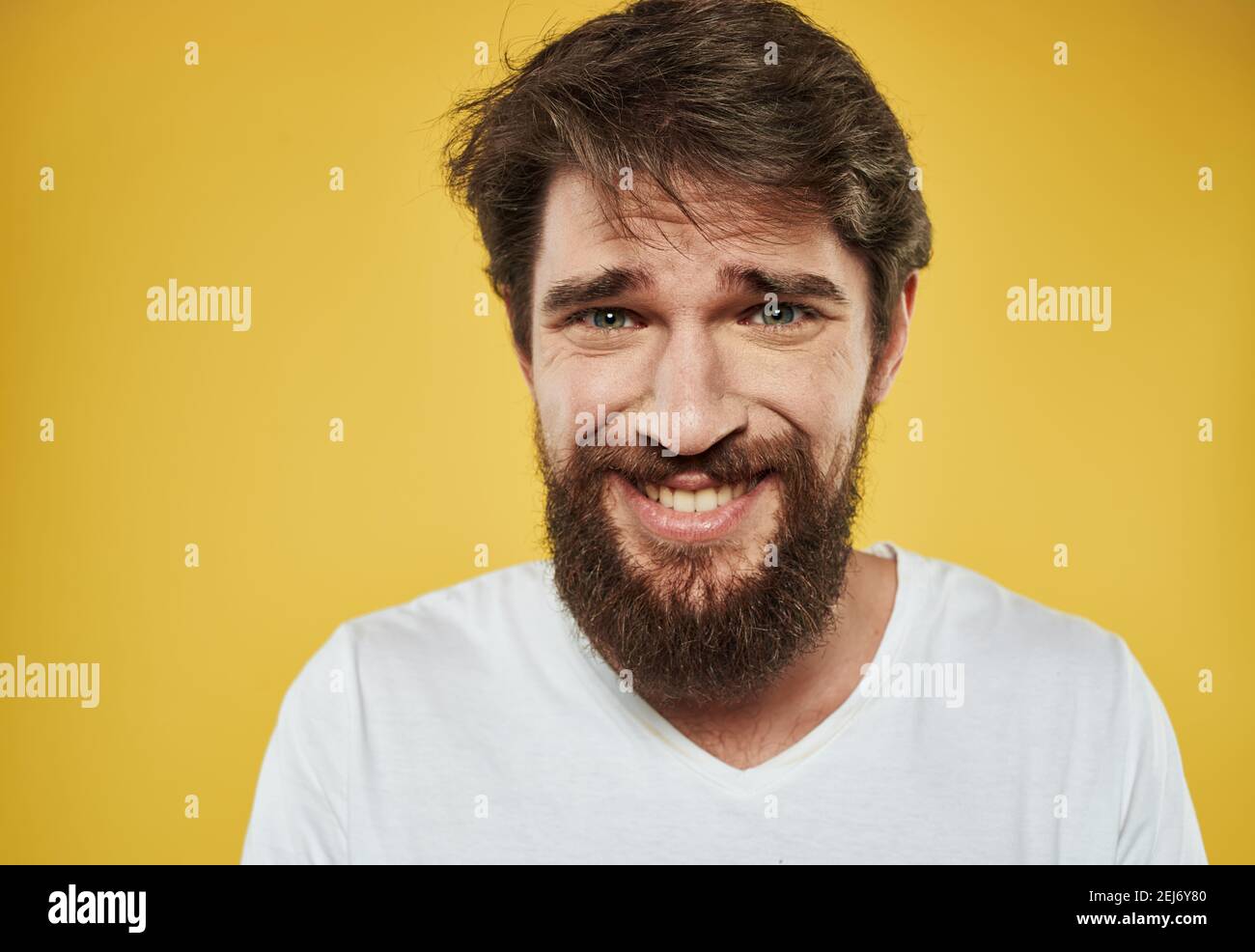 Emotional man with thick beard grinning model yellow background Stock ...