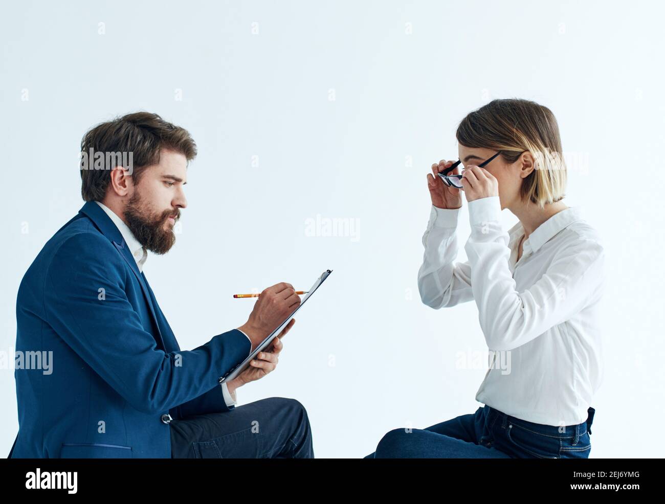 Emotional woman and young man communication on a light background ...
