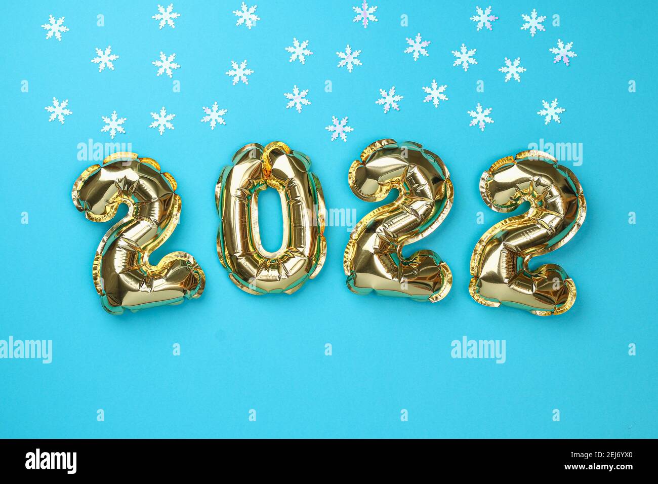 New Year 2022. Foil balloons numbers 2022 on a blue background. New ...