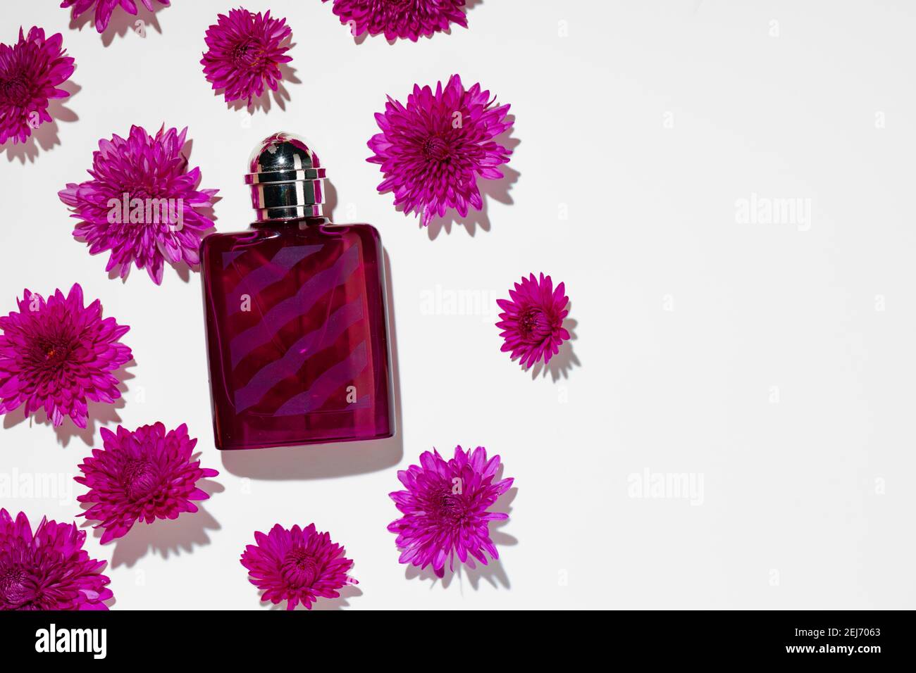 Bottle of fragrance surrounded by flower buds Stock Photo - Alamy