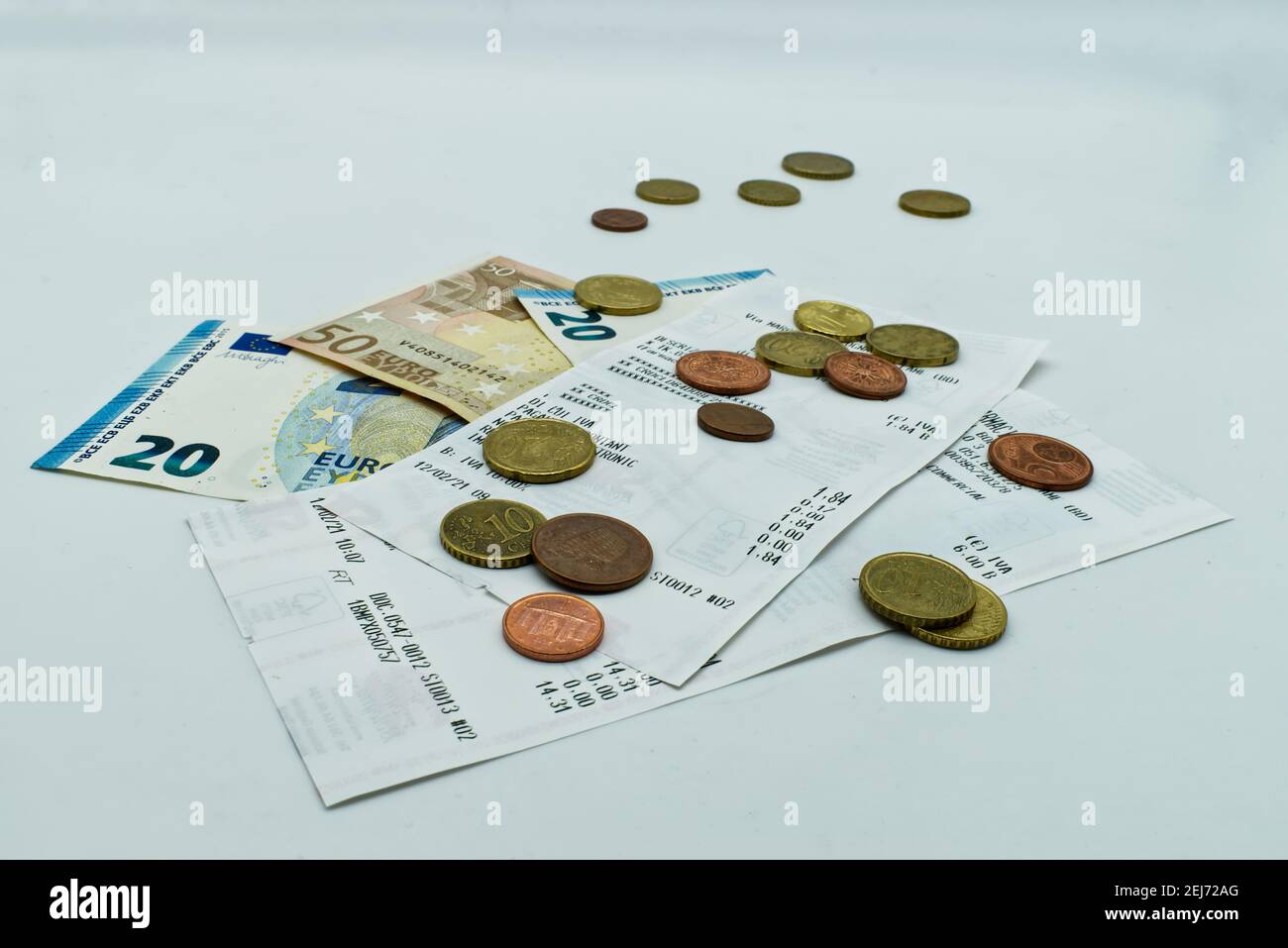 Euro banknotes, Euro coins and receipts isolated on white background ...