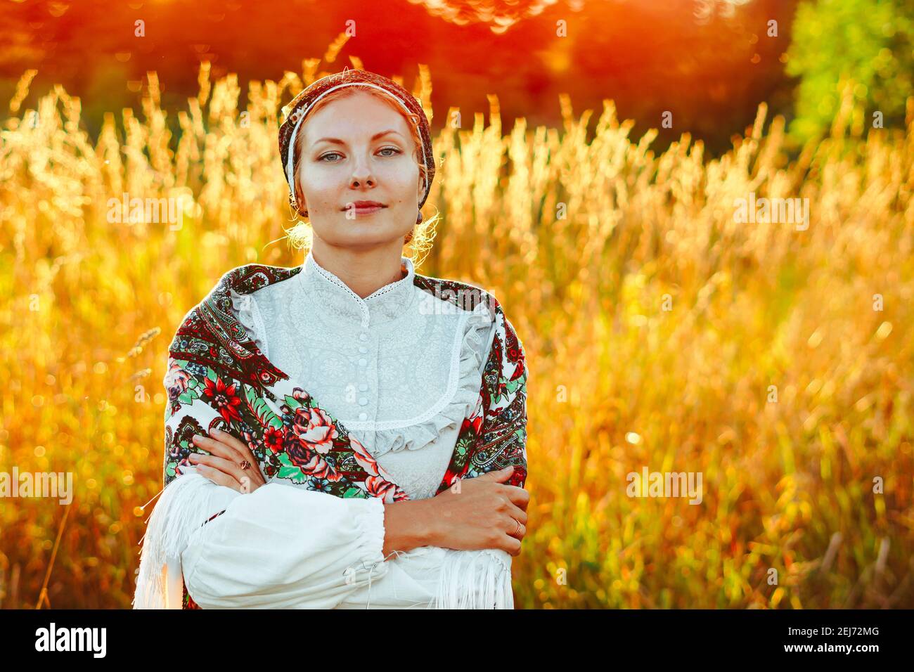 Young beautiful slovak woman in traditional costume on summer daisy ...