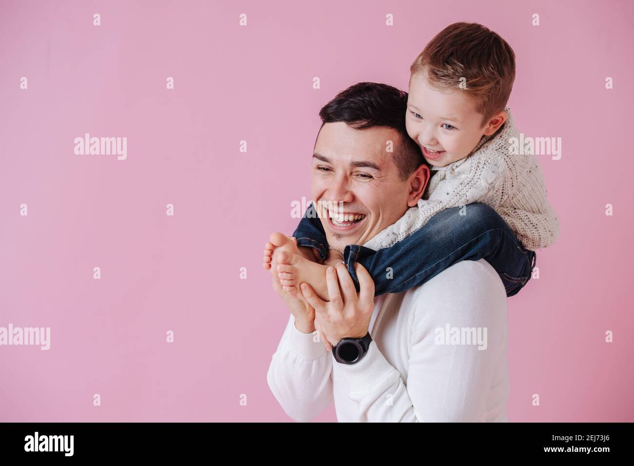 Kid son riding dads shoulders hi-res stock photography and images - Alamy