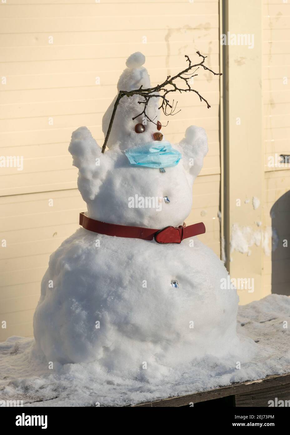 beautiful white snowman with red belt and face mask, covid-19 restraint ...