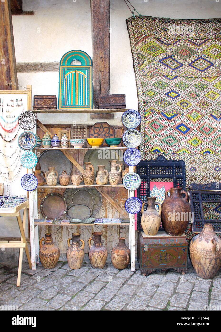 Traditional moroccan souvenirs - carpet, plates, jugs and pots made of ...