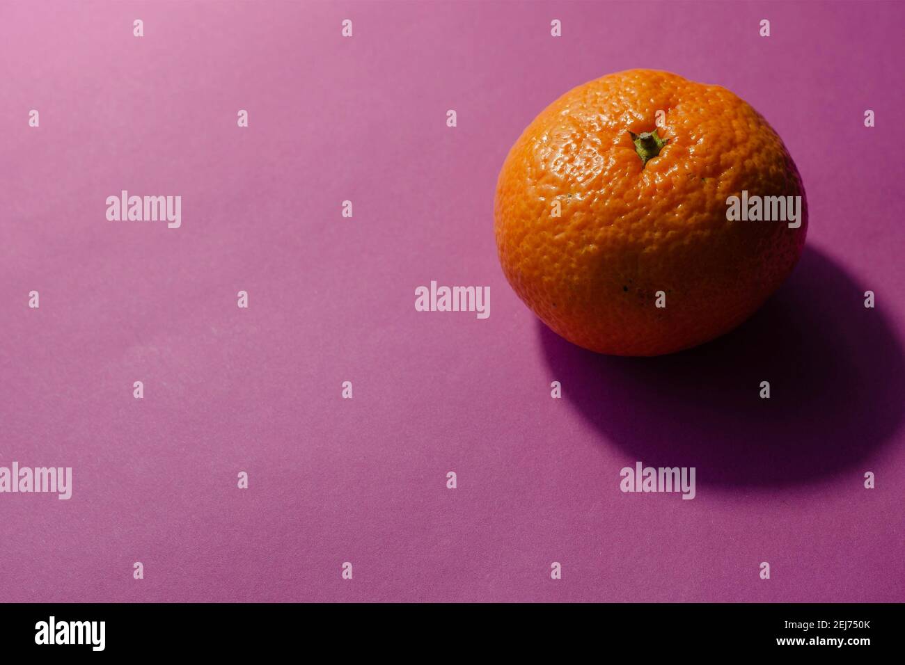 Minimalist composition with mandarin on pink background. Single ...