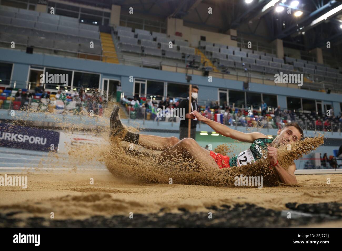 ISTANBUL, TURKEY - FEBRUARY 20, 2021: Undefined athlete long jumping ...