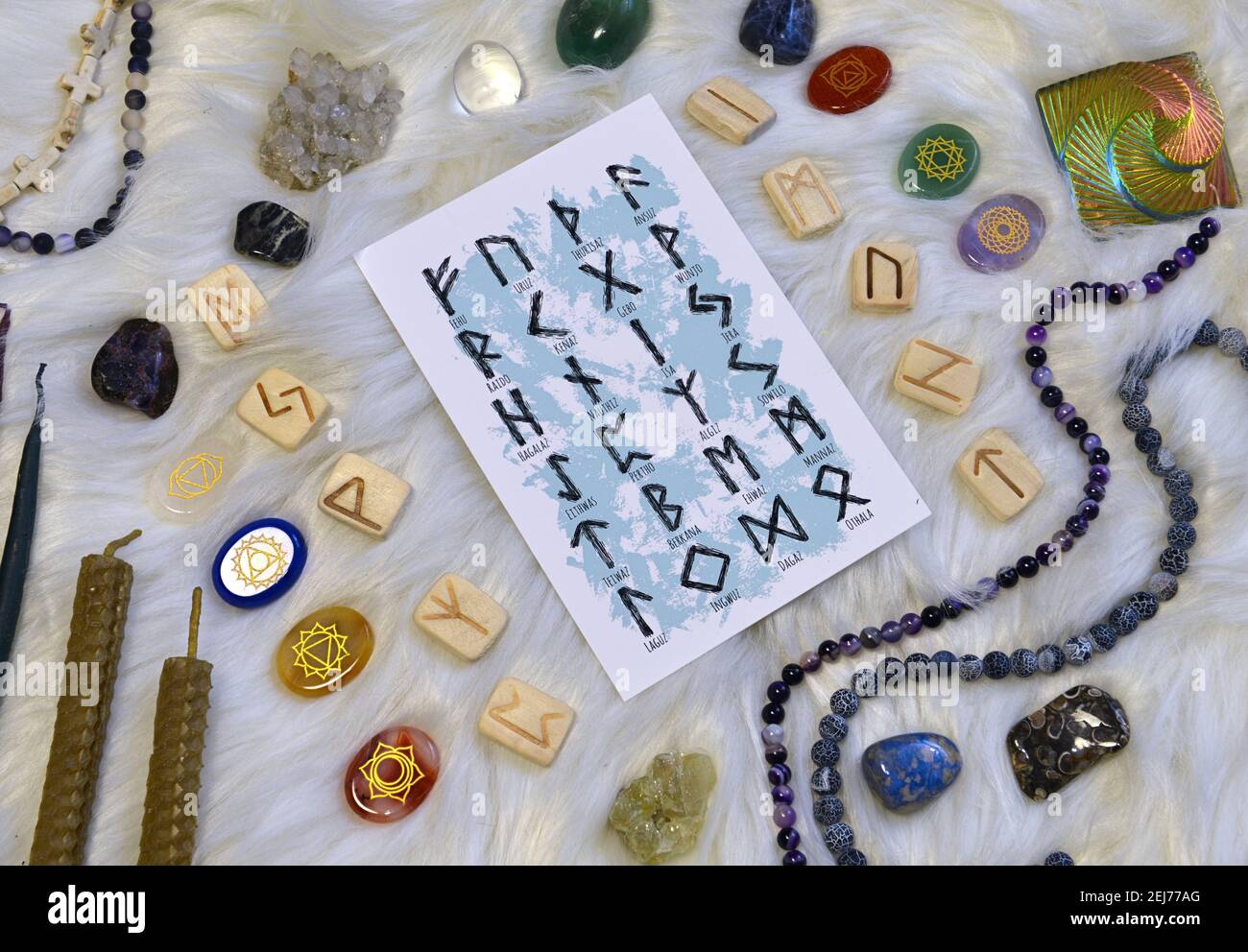 Still life with runes, chakras symbols on stones and ritual objects ...