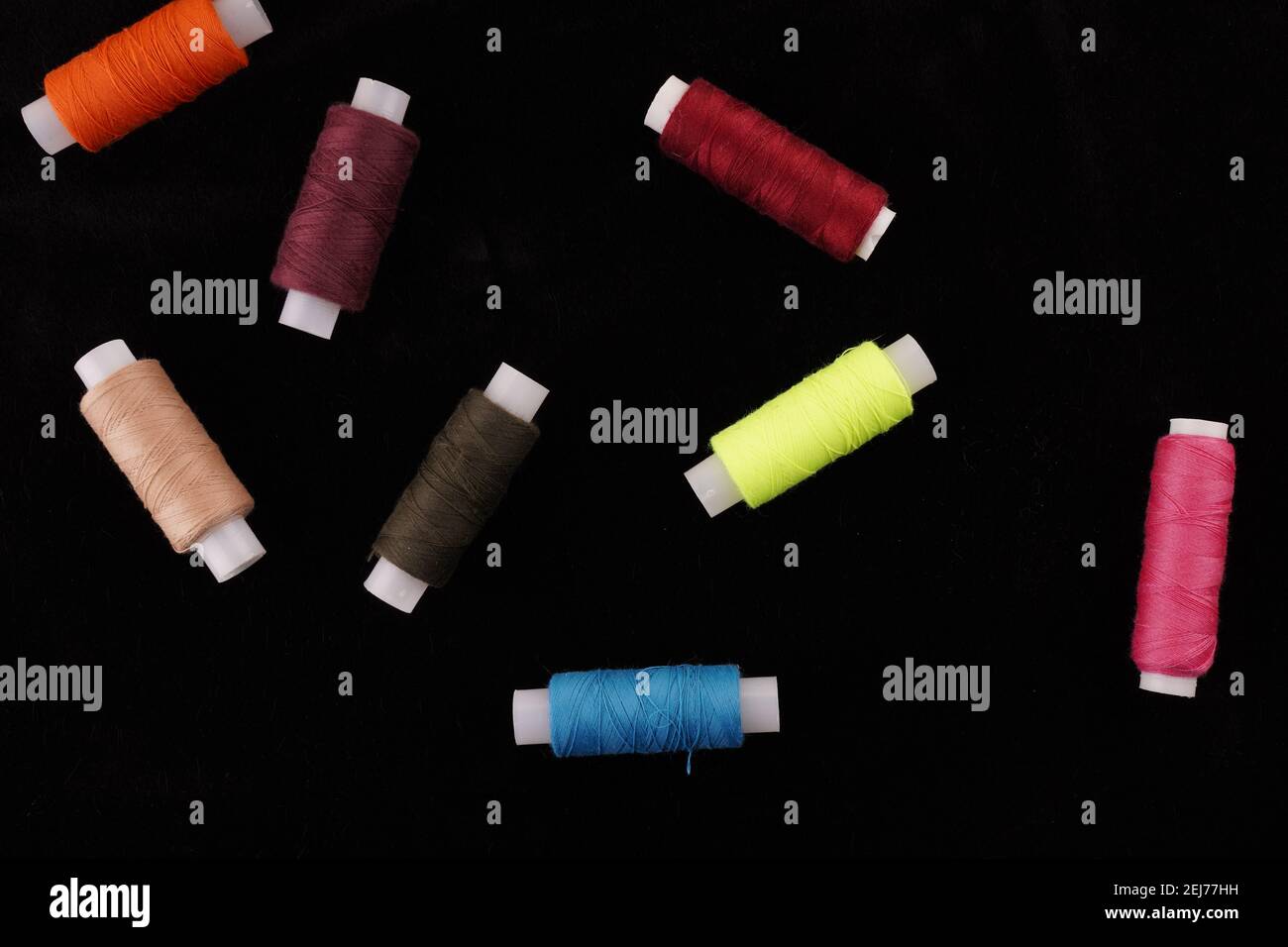 colored threads on a black background Stock Photo - Alamy