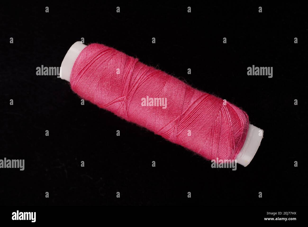 colored threads on a black background Stock Photo - Alamy