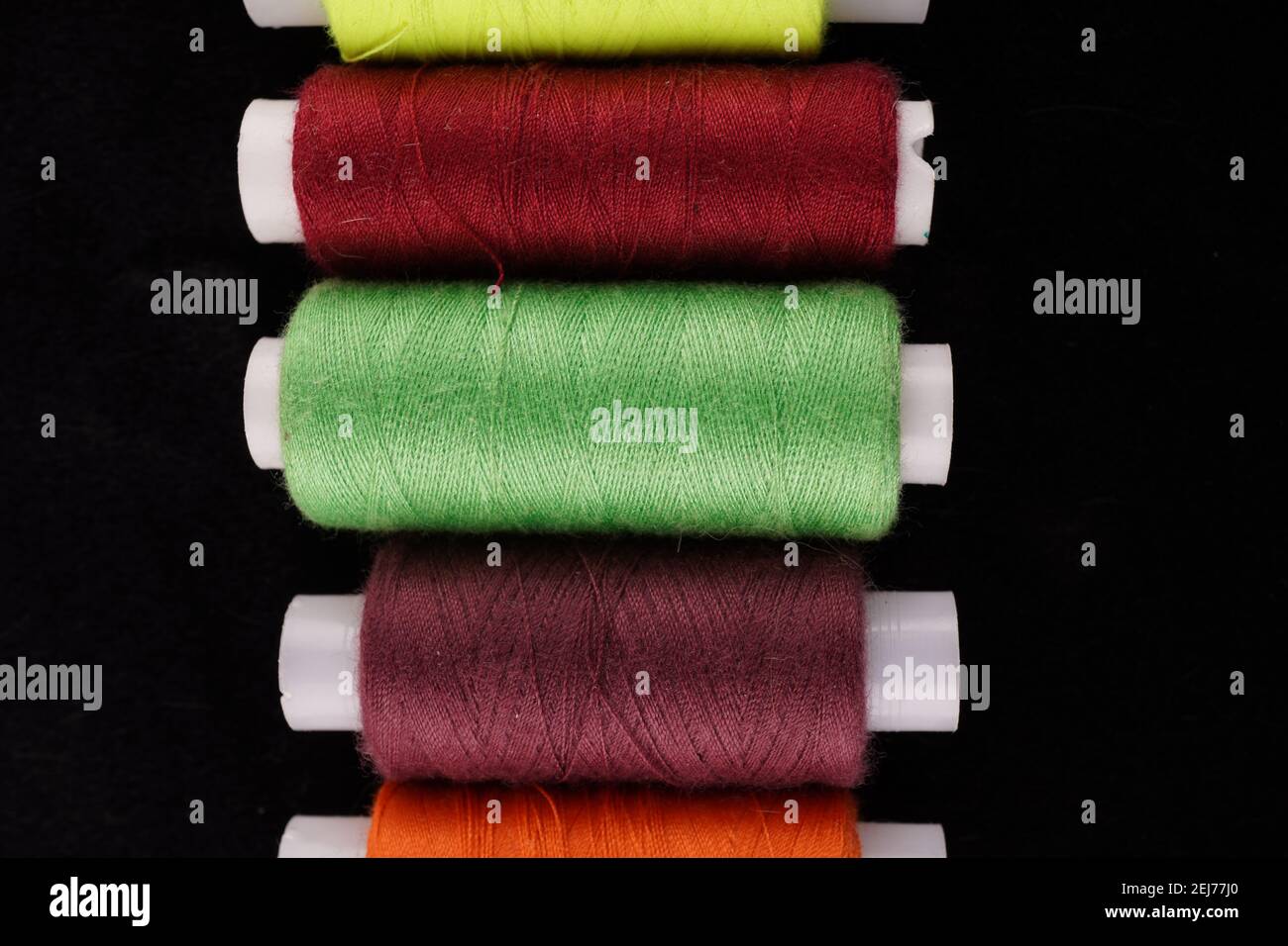 colored threads on a black background Stock Photo - Alamy