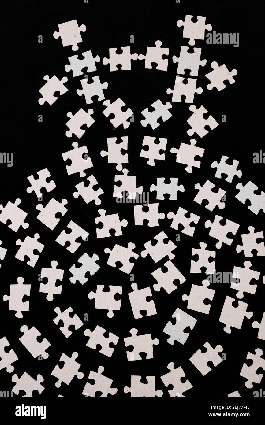 puzzle figures on a black background Stock Photo - Alamy