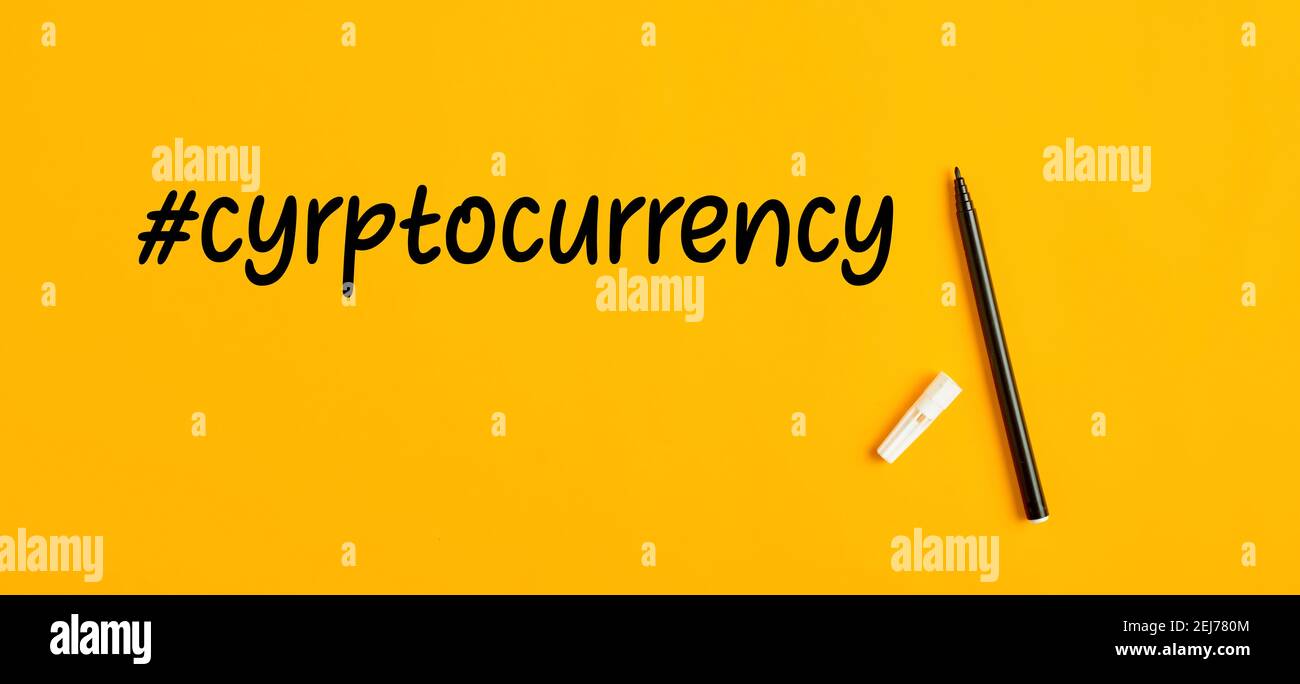 The word cryptocurrency hand written with hashtag symbol and a pen ...