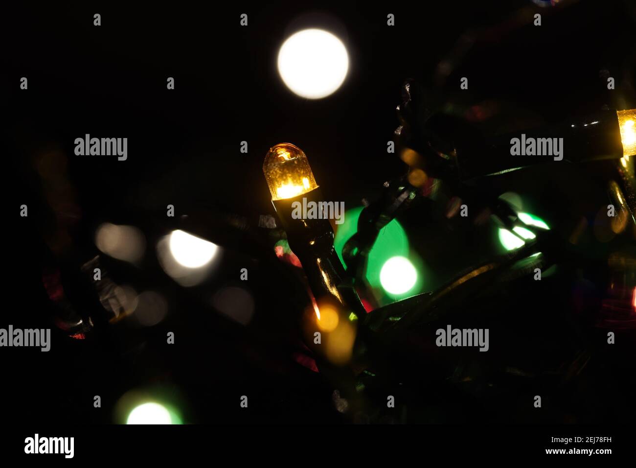 colored garland on a black background Stock Photo - Alamy