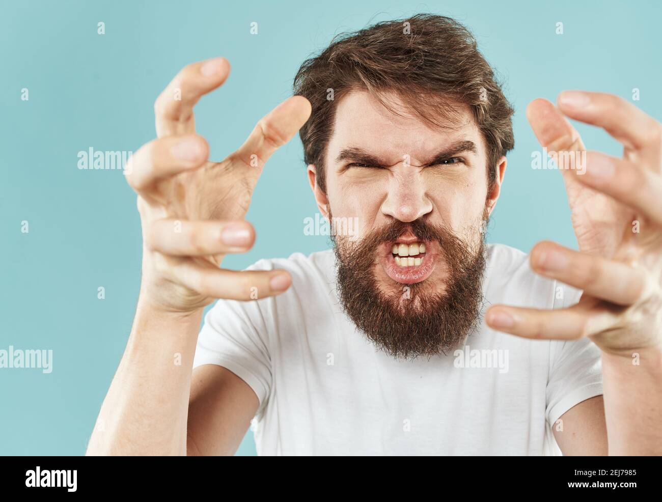 aggressive man yelling on blue background stress irritability emotions ...