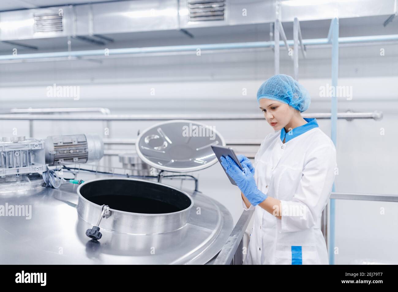 Food automated modern industrial production. Operator worker woman ...