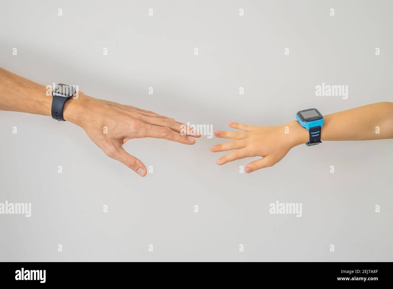 Dad's hand reaches for the hand of the child in the smart children's ...