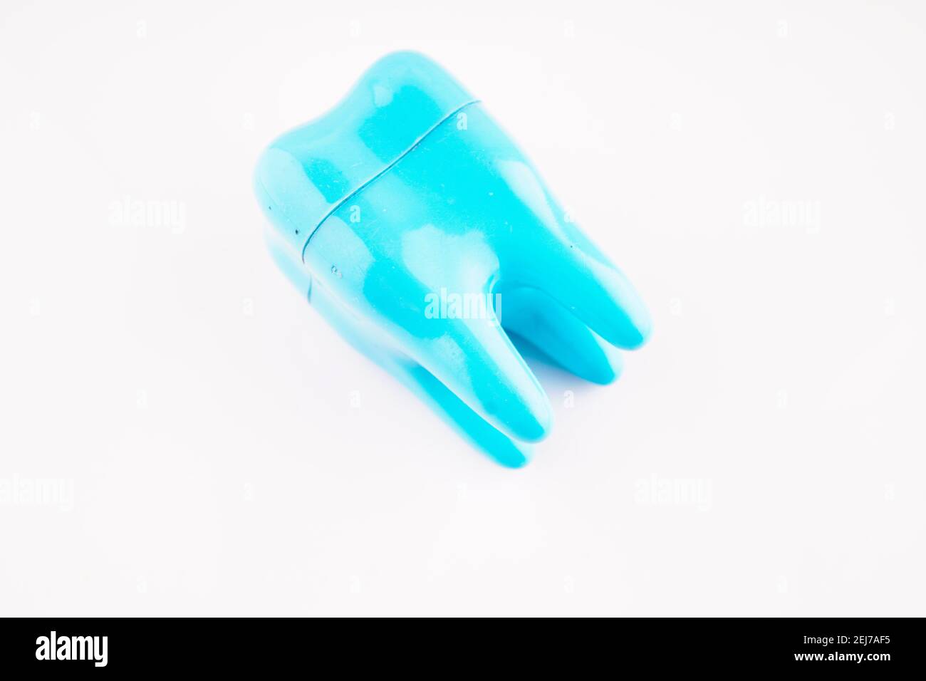 plastic toy tooth on white background Stock Photo - Alamy