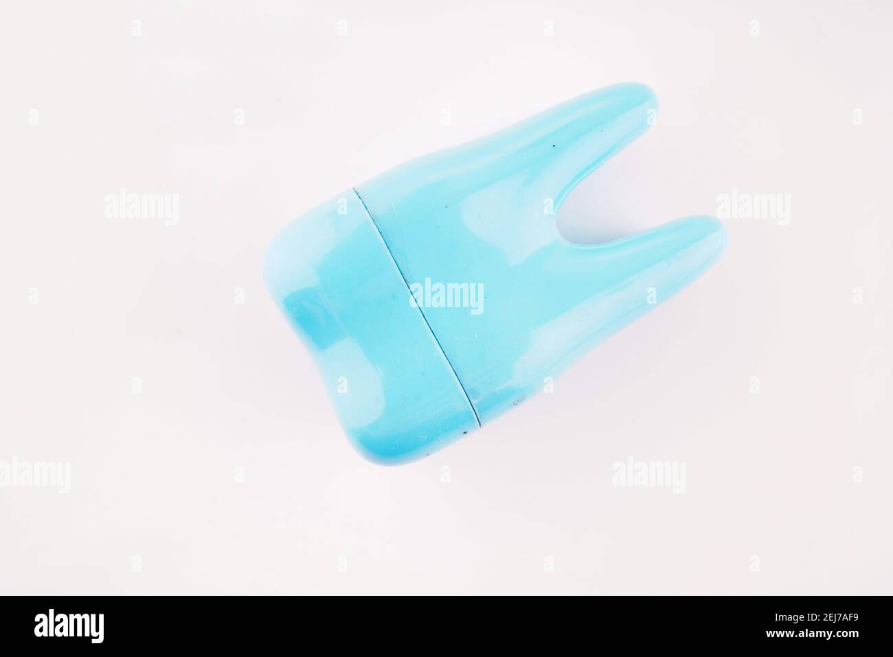 plastic toy tooth on white background Stock Photo - Alamy