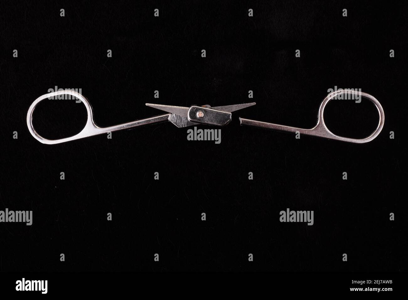 broken metal scissors on black background Stock Photo - Alamy