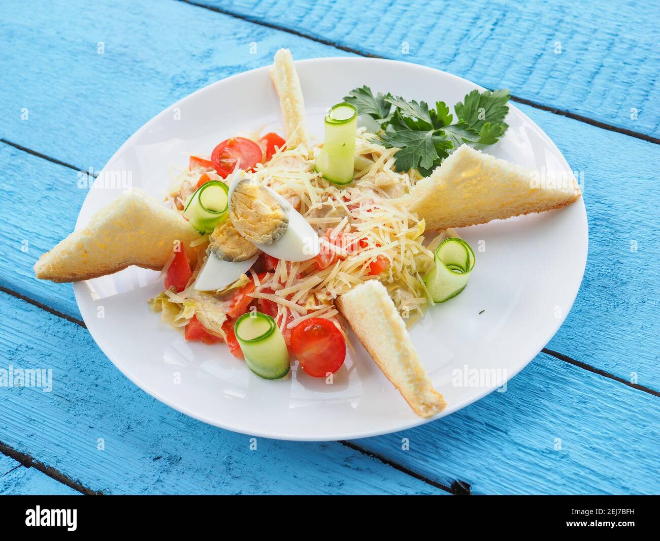 Salad with crab sticks on blue wooden background Stock Photo - Alamy