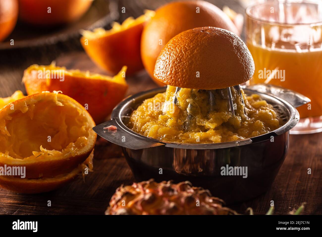 Freshly squeezed orange in a manual juicer with pulp, juice and orange ...