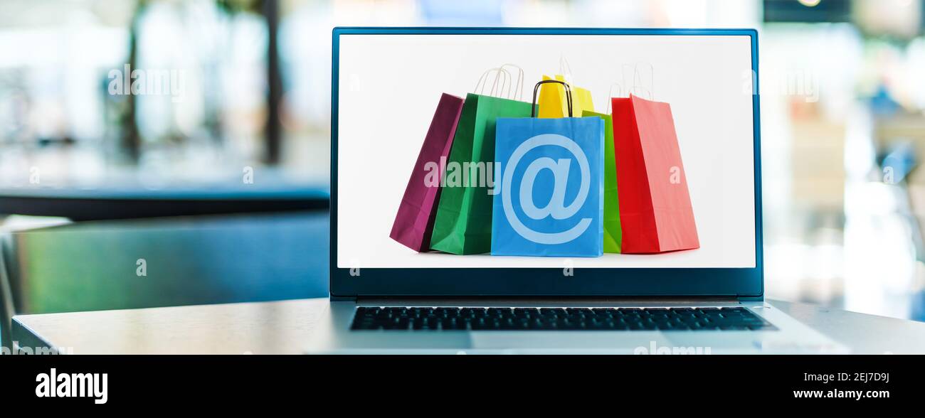 Paper shopping bags on laptop computer screen. Shopping online. E ...