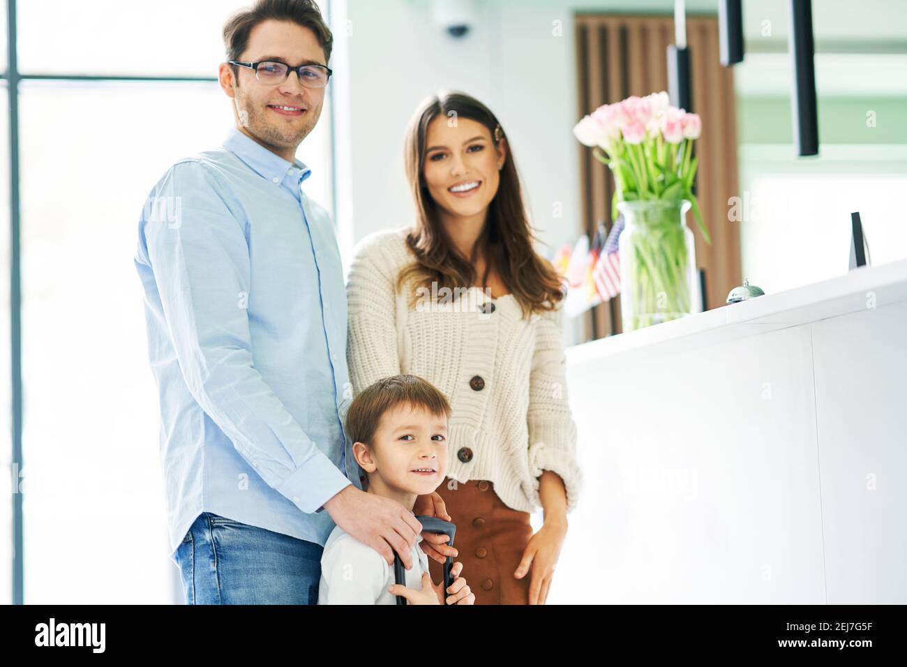 Picture of family checking in hotel Stock Photo - Alamy