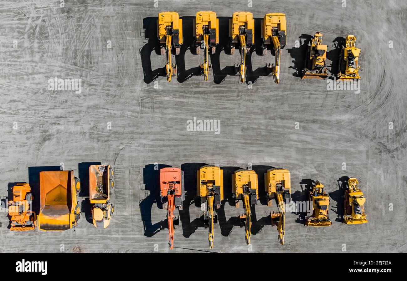 Large parking lot with big yellow mining truck, bulldozers for coal ...