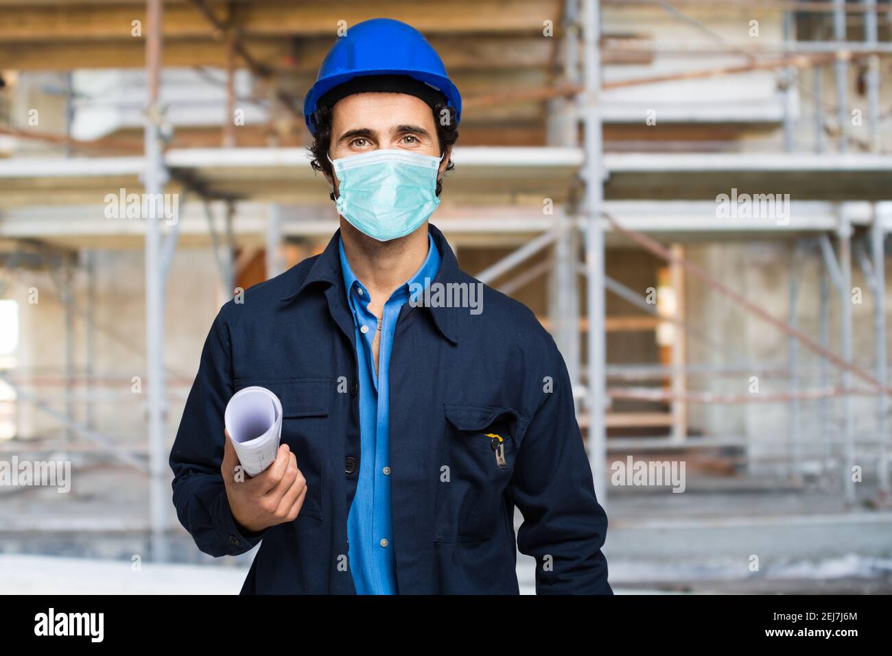 Masked architect portrait in a site plant, covid coronavirus ...