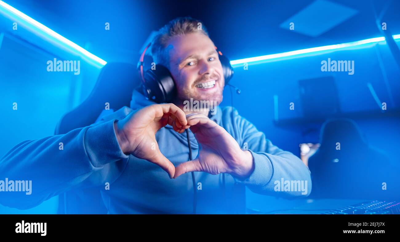 Streamer beautiful man shows heart sign with hands professional gamer ...
