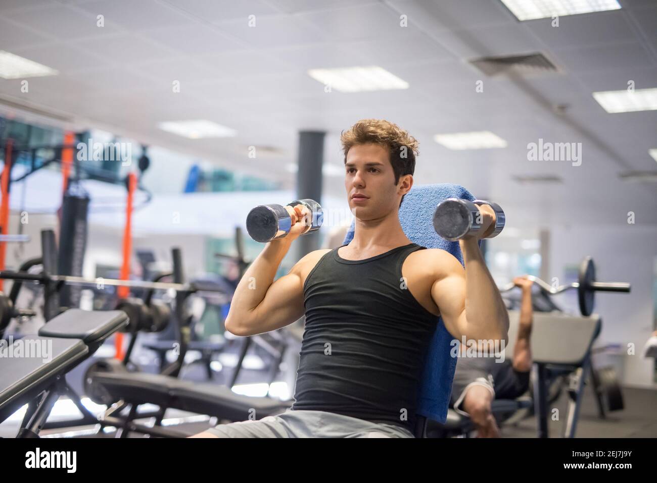 Bodybuilder using a dumbbell to work out his arms in a gym Stock Photo ...