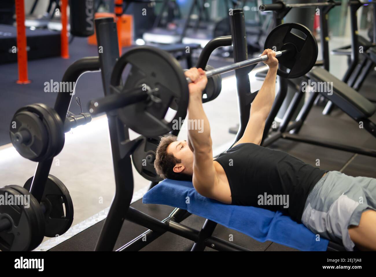 Bodybuilder training by lifting a weight on the flat bench Stock Photo ...