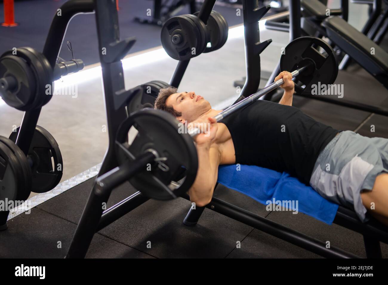 Bodybuilder training by lifting a weight on the flat bench Stock Photo ...