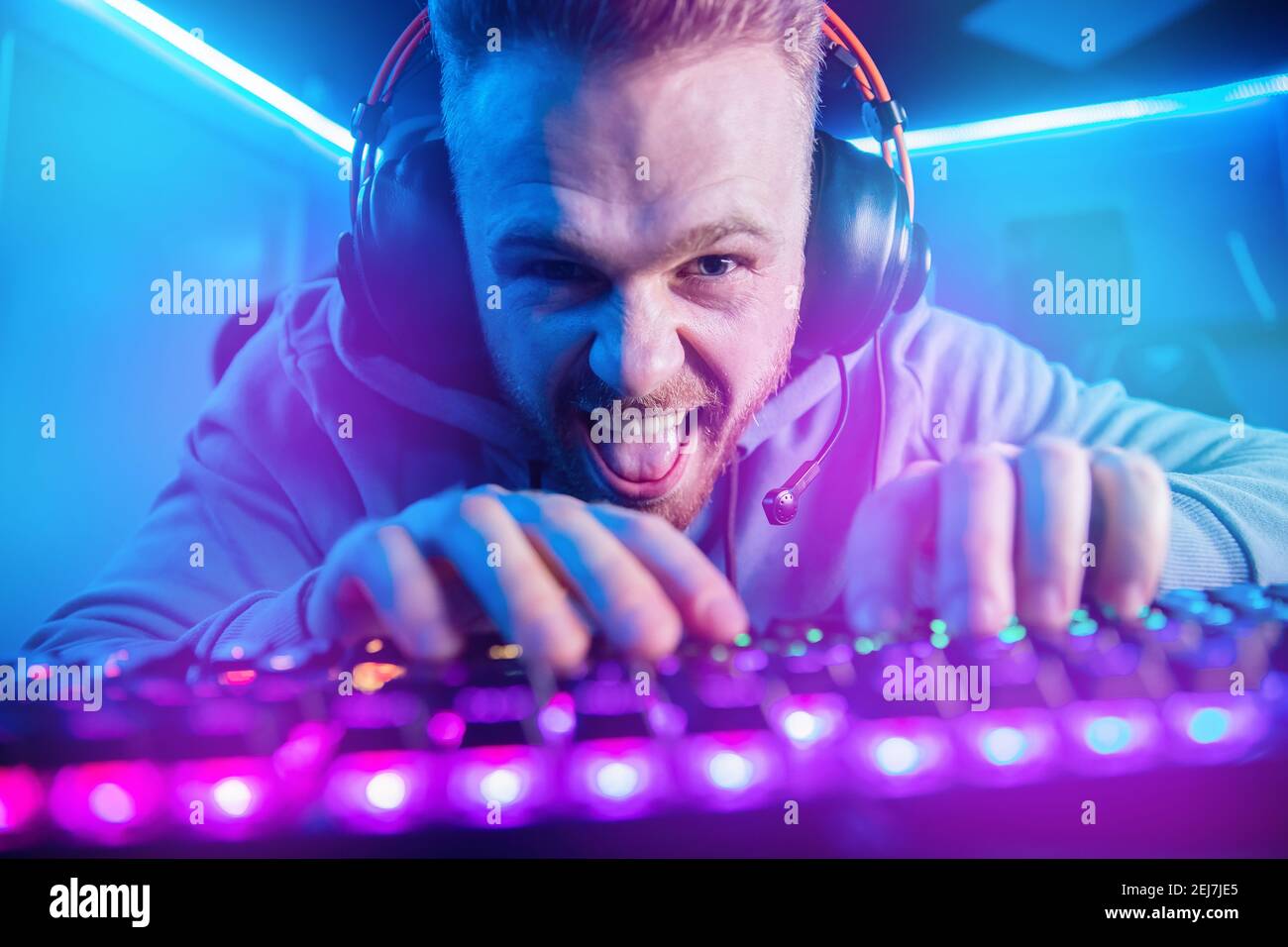 Streamer young man rejoices in victory professional gamer playing ...