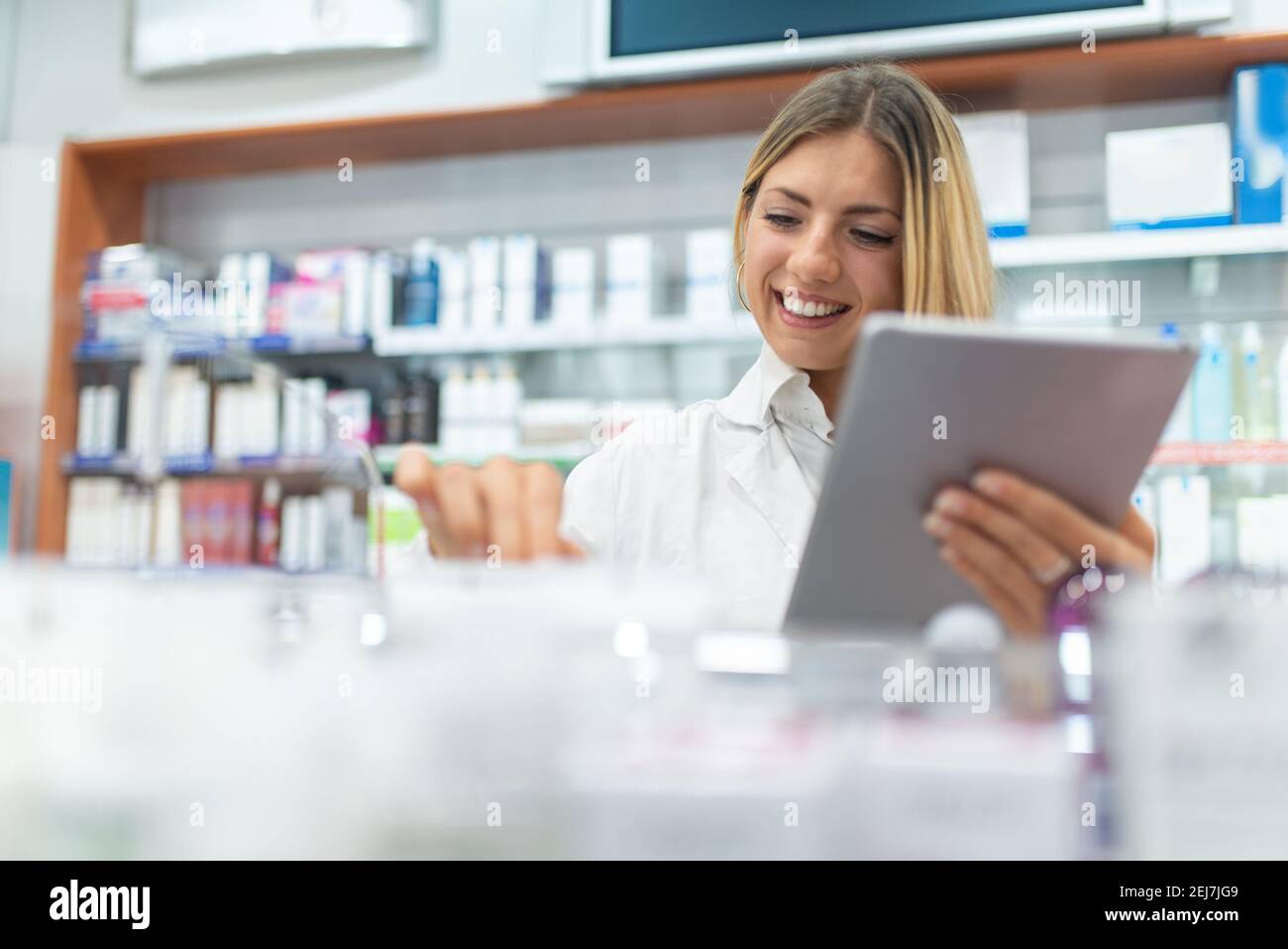 Young female pharmacist checking the inventory in a pharmacy Stock ...
