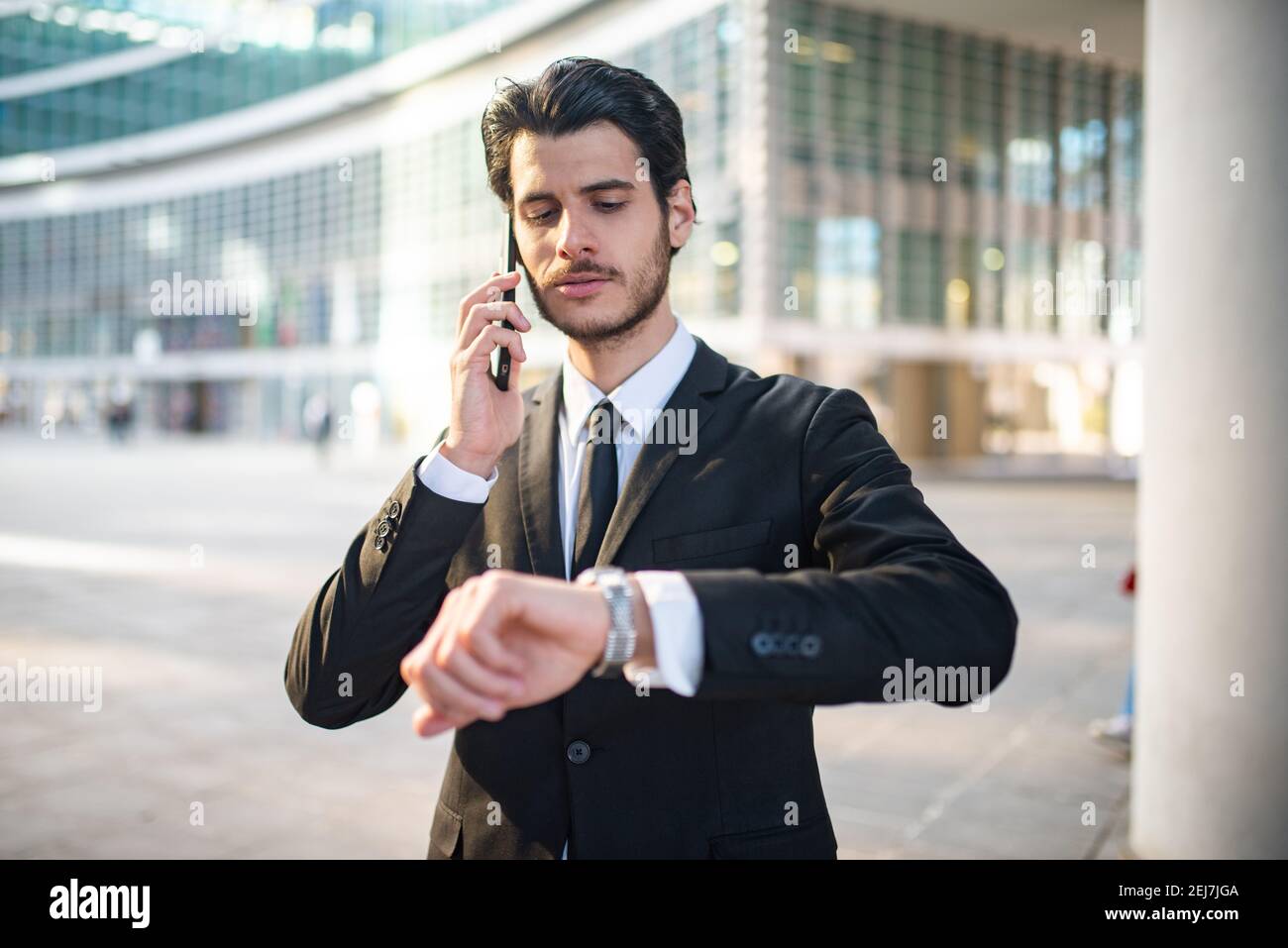 Employee watching wrist watch hi-res stock photography and images - Alamy