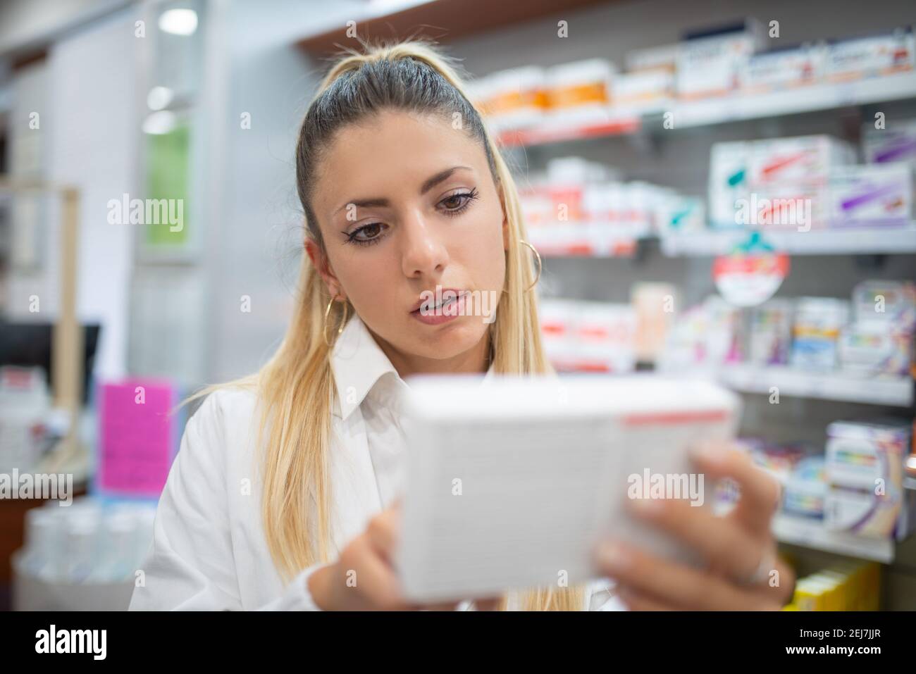 Chemist checking drugs shelf hi-res stock photography and images - Alamy