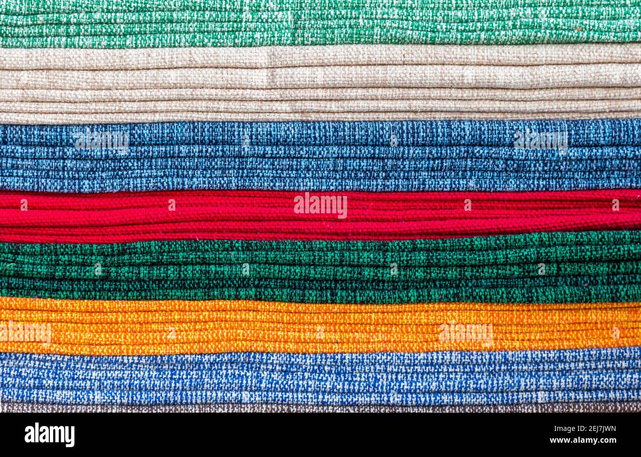 Closeup shot of stacked fabrics in different colors Stock Photo - Alamy